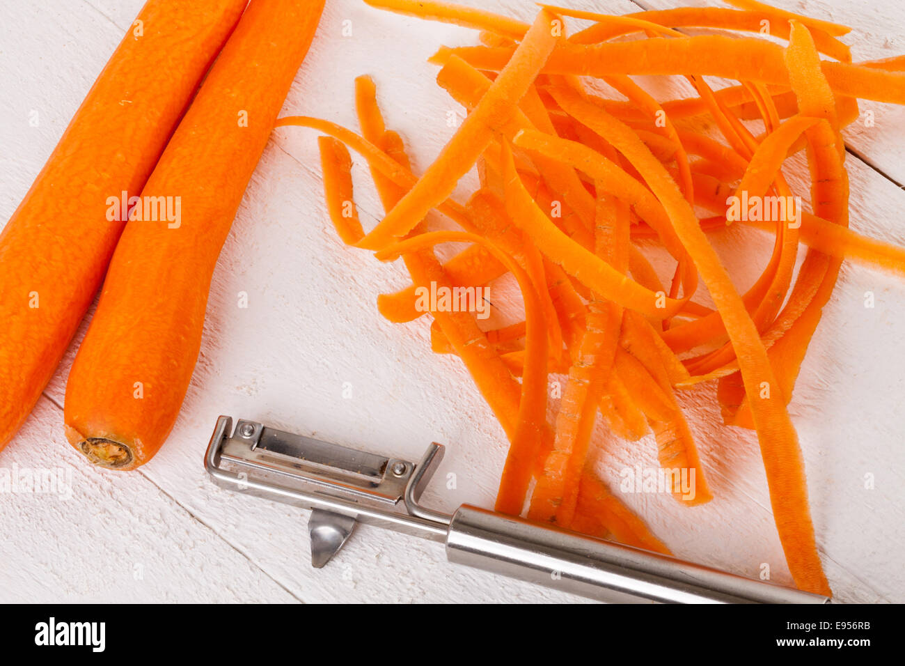 Fresh peeled carrots sliced into thin batons for carrot julienne with a ...