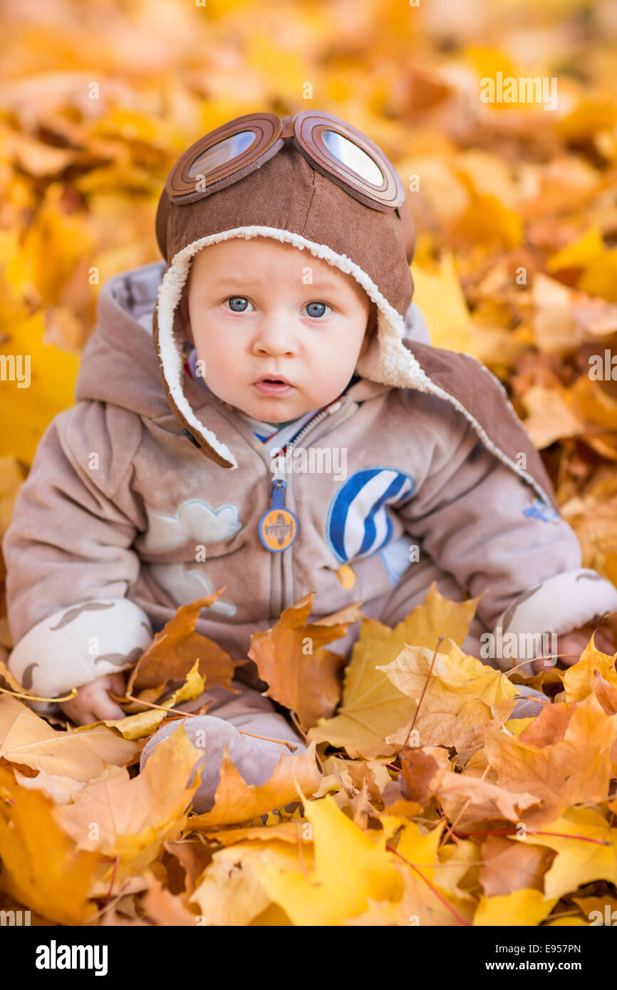 Cute baby in autumn leaves. First autumn Stock Photo - Alamy