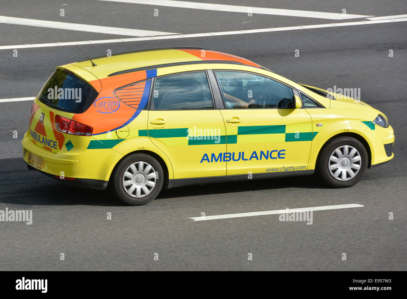 Private ambulance car (operated by "Caring for You") driving along ...