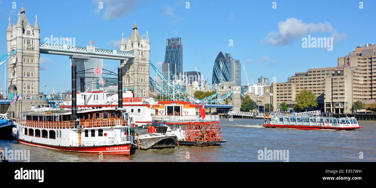 Replica paddle boat and tour boats on the River Thames with Tower ...