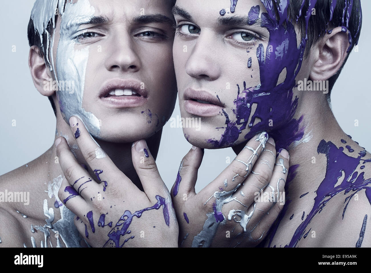 two cold men in silver and violet paint Stock Photo - Alamy