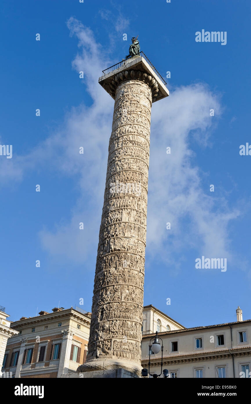 Bas relief of roman battles and St Peter statue on top of the column of ...