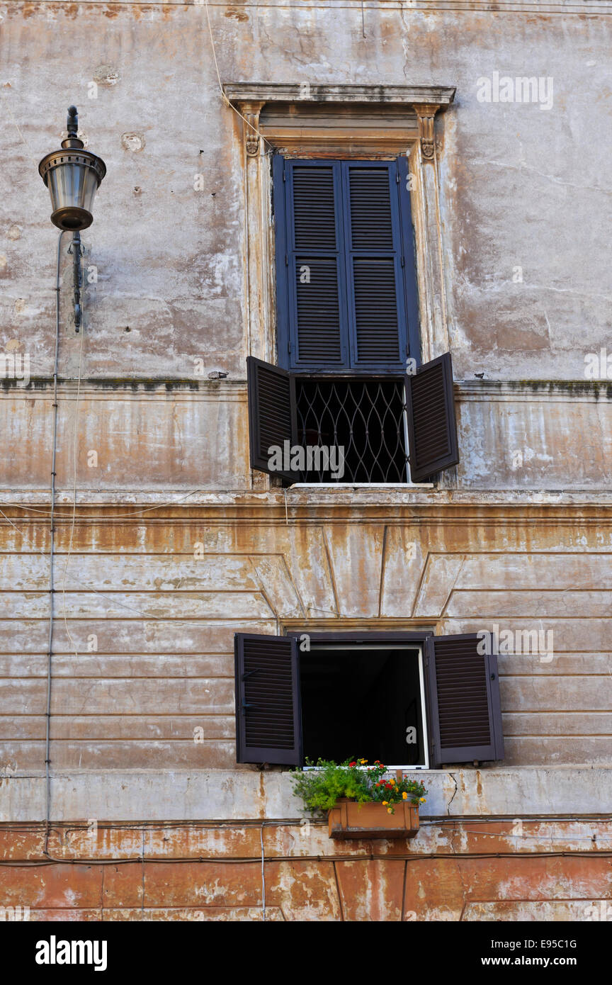 The exterior wall of a traditional Italian building with windows and ...