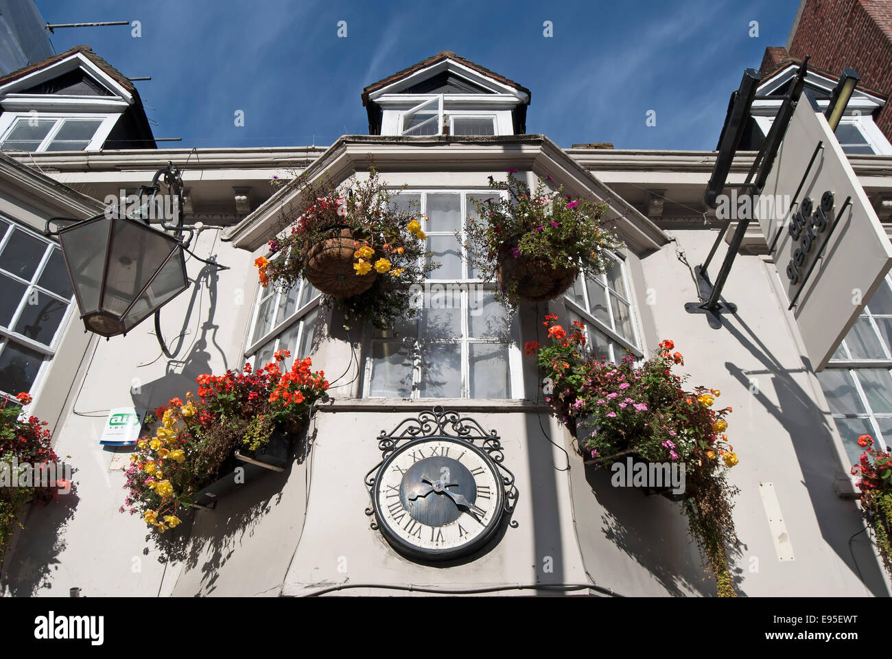 exterior, with hanging baskets and roman numeral clockface, of the ...