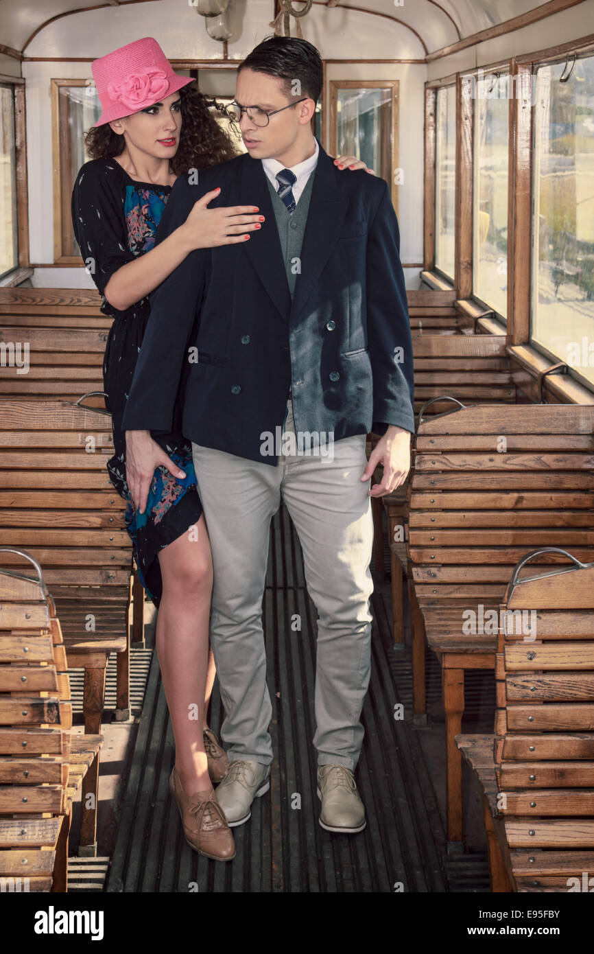 Beautiful vintage style couple inside retro train coach have an ...