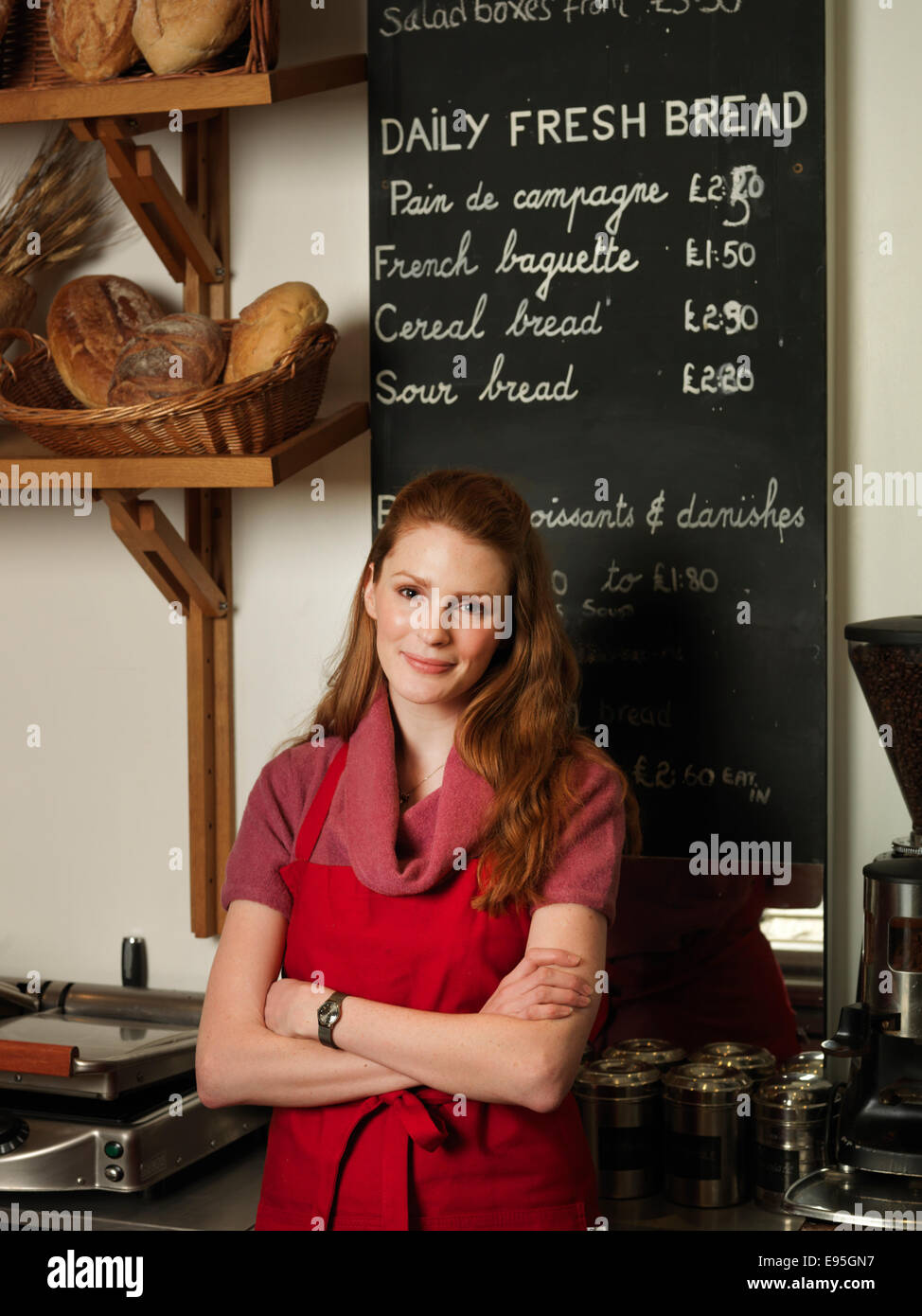 Beautiful Bakery shopkeeper shows bread Stock Photo - Alamy