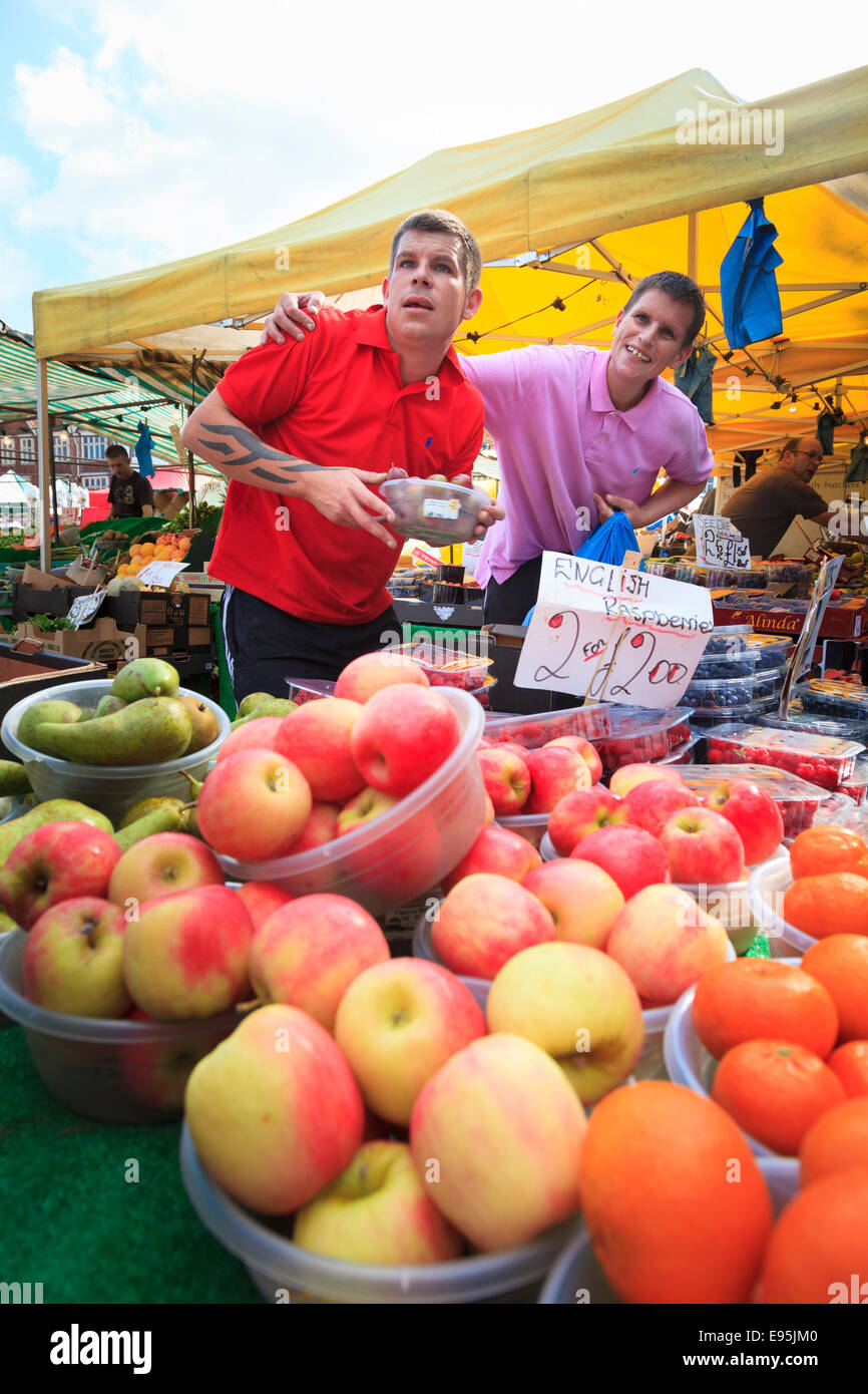 Two market traders selling fruit and reacting to being photographed ...