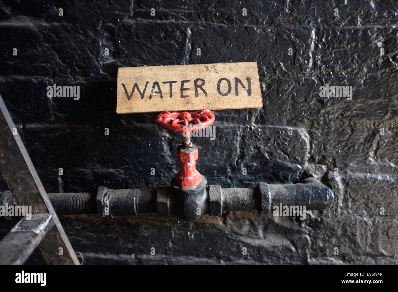 Red water tap with handwritten Water On wooden sign Stock Photo - Alamy