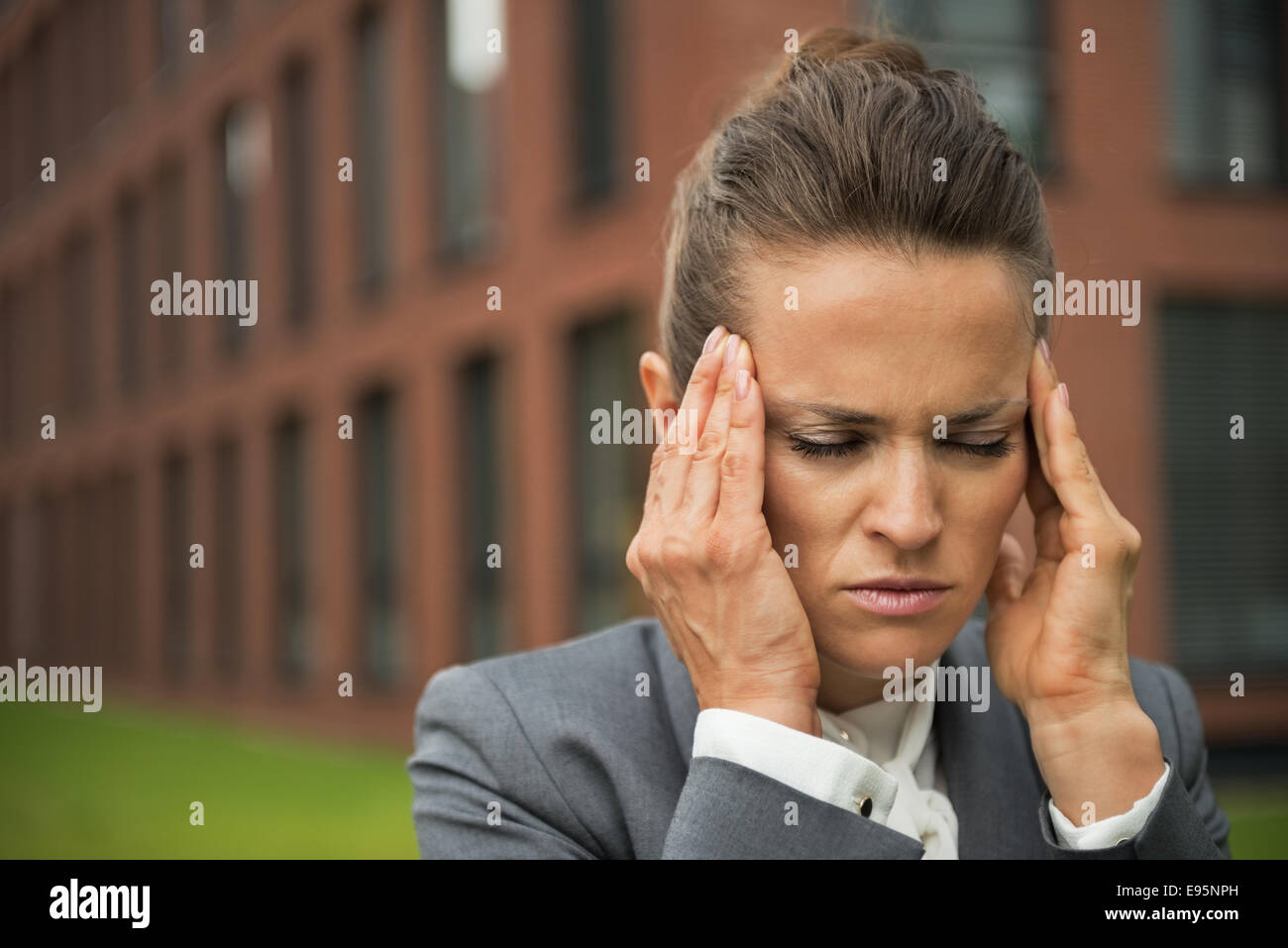 Portrait of stressed business woman in front of office building Stock ...