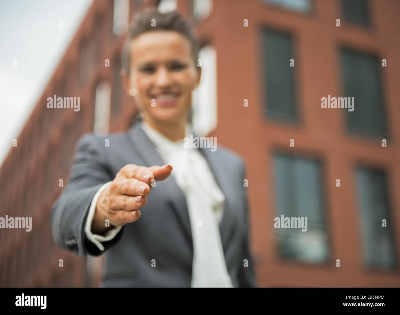 Closeup on happy business woman stretching hand for handshake in front ...