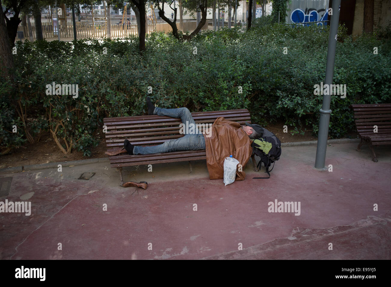 Homeless sleeping on a bench in Barcelona Stock Photo - Alamy