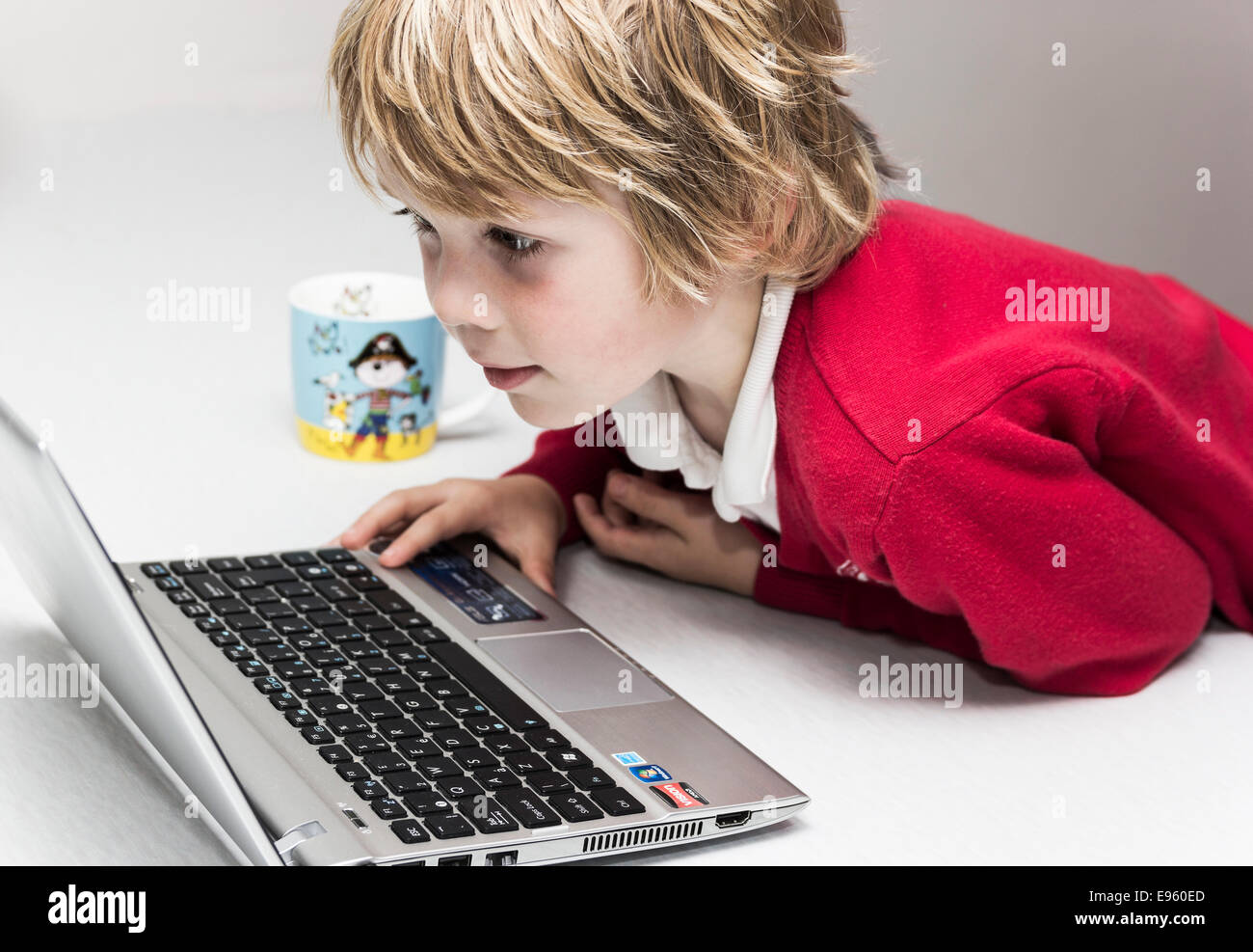 Five year old boy concentrates on a computer screen Stock Photo - Alamy