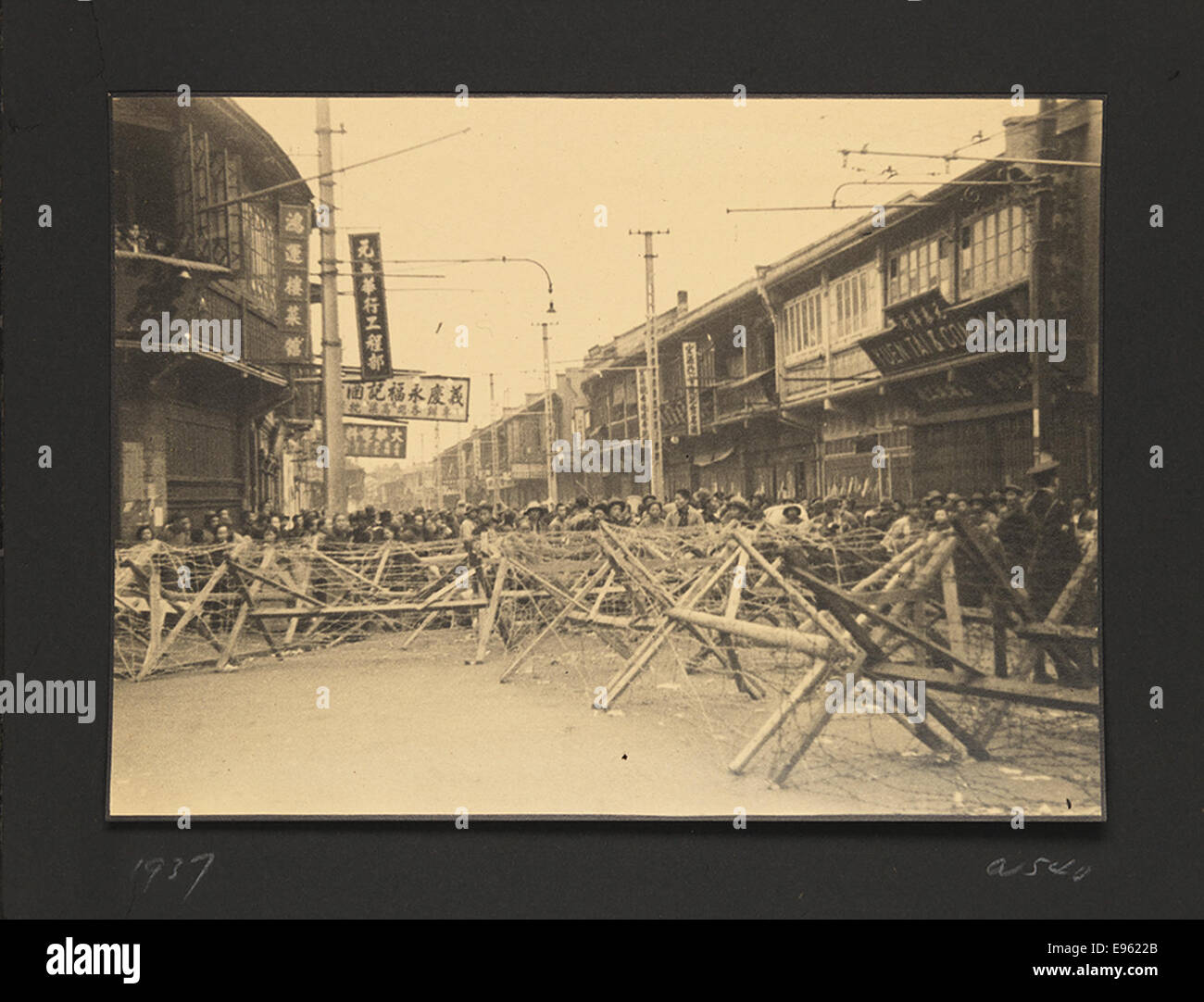 A photograph depicting a barbed wire barricade at a Japanese military ...