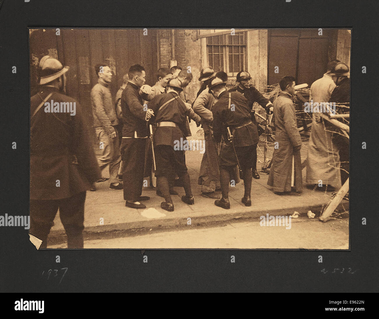 This black and white photograph captures Chinese civilians in ...