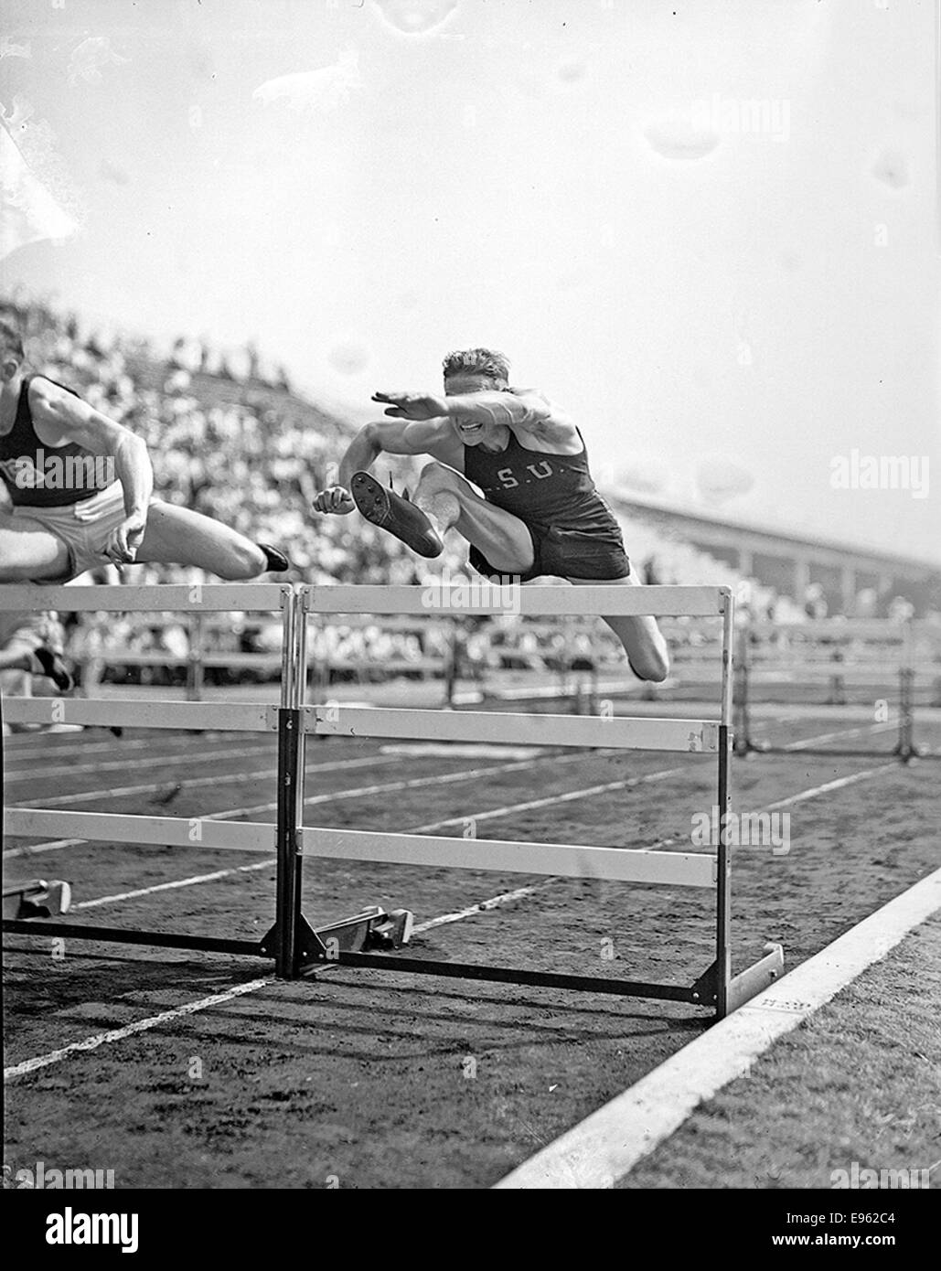 This photo captures Glenn Hardin competing in the hurdles during the ...
