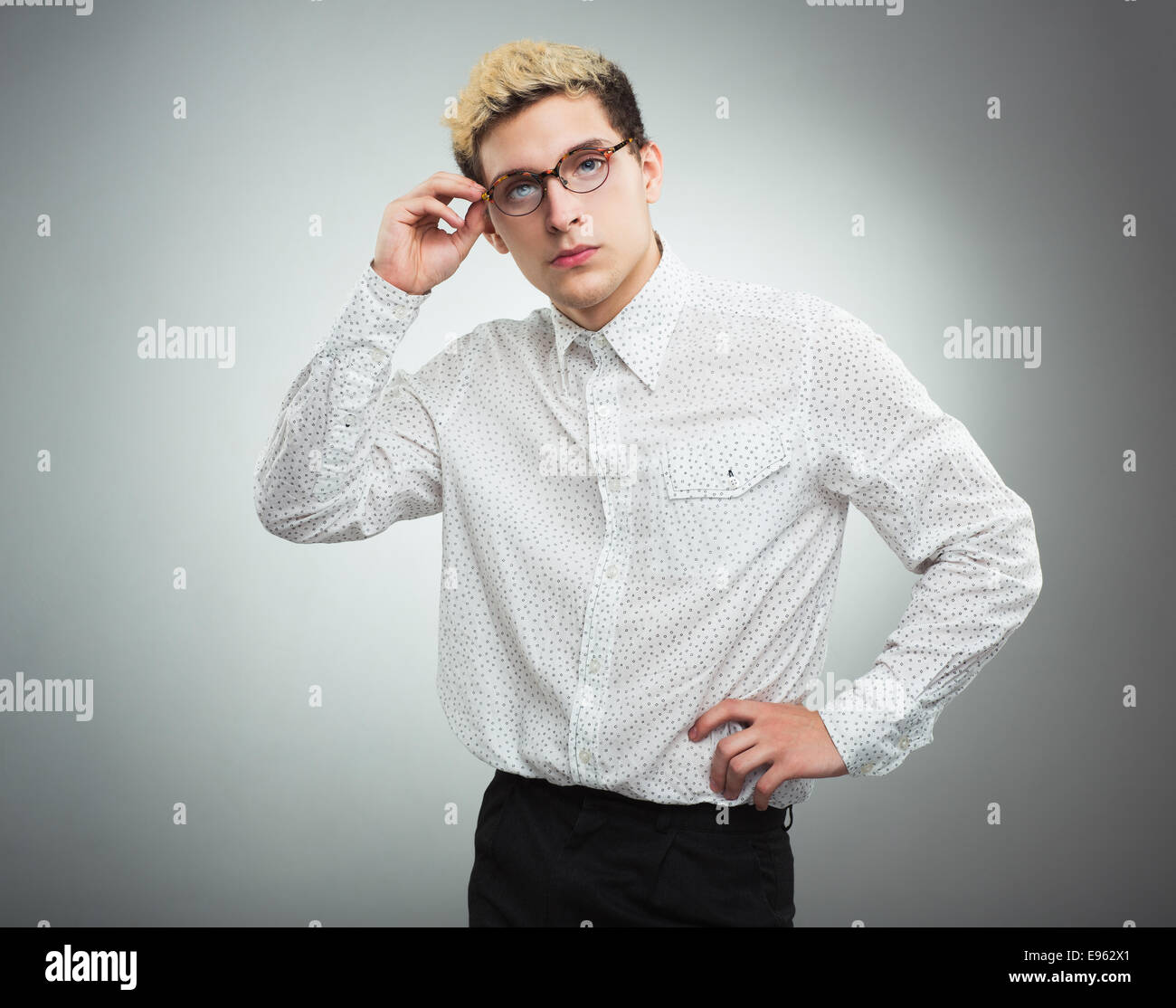 Young serious man looking to the camera wearing glasses Stock Photo - Alamy
