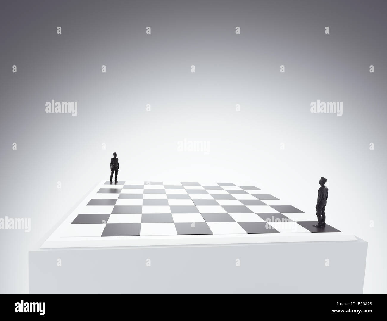 Two tiny figures standing on a chess board - conflict and competition ...