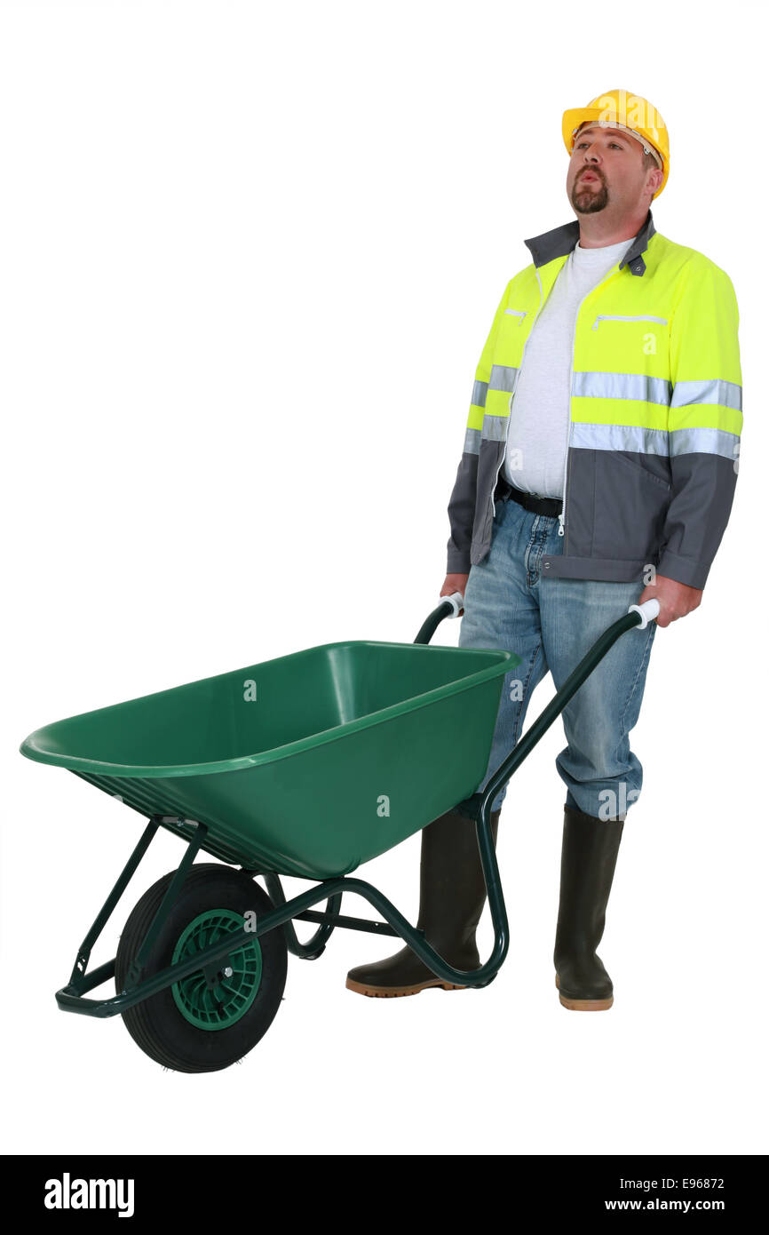 Construction worker with a wheelbarrow Stock Photo - Alamy