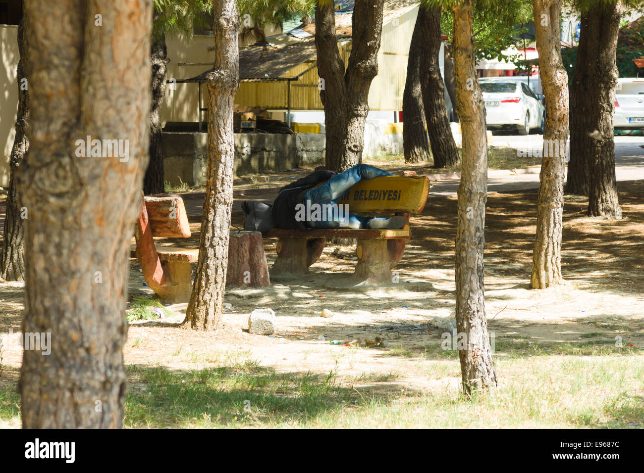 Homeless sleeping on a park bench. Avsallar - is a popular tourist ...