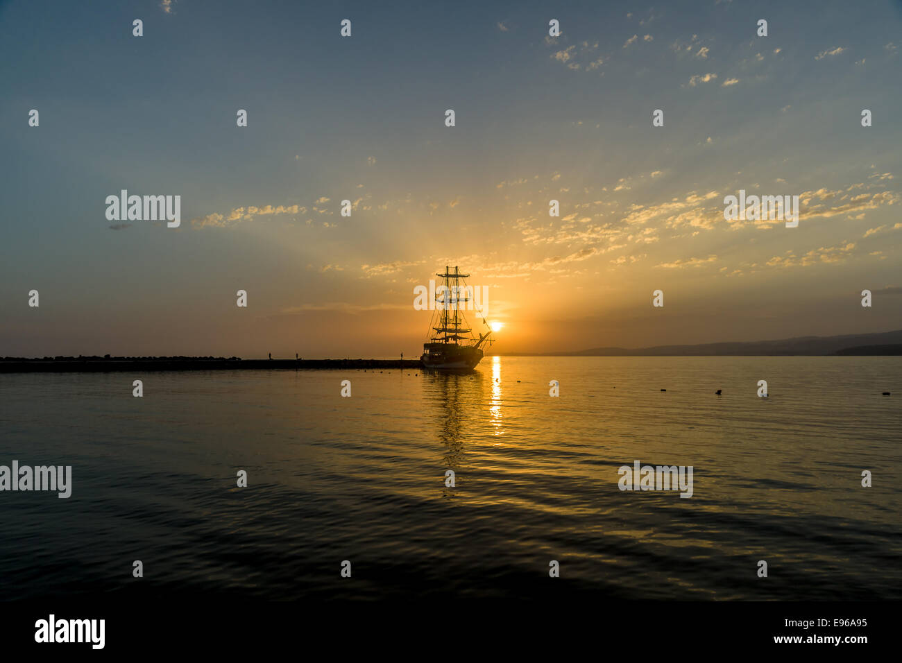 Evening. Sailboat in the bay Stock Photo - Alamy