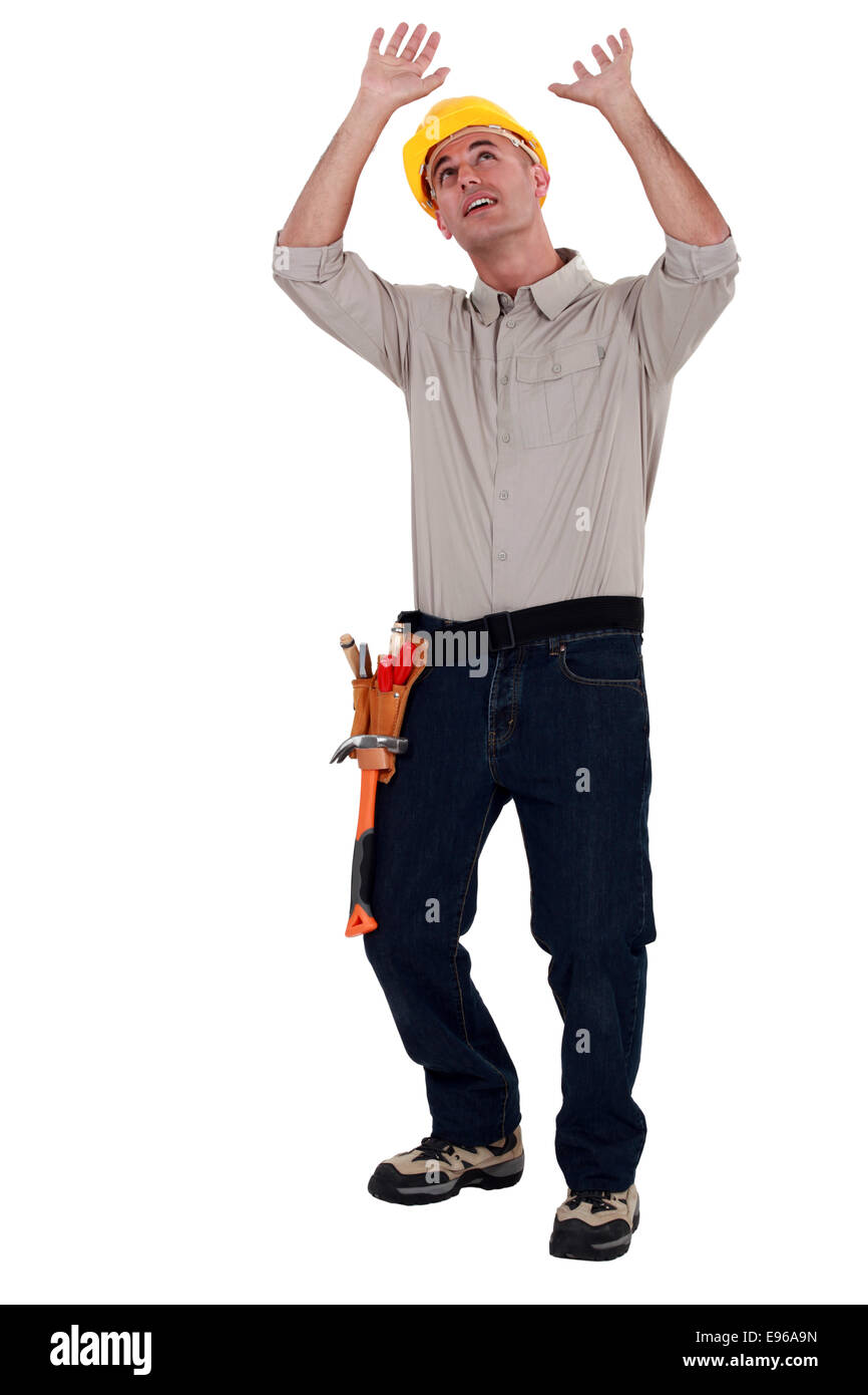 Laborer gesturing on white background Stock Photo - Alamy
