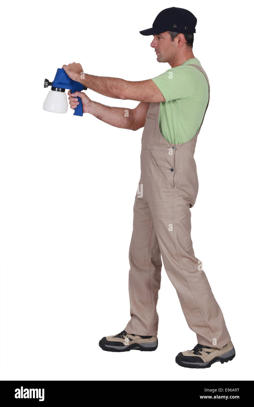 Man using paint sprayer Stock Photo - Alamy