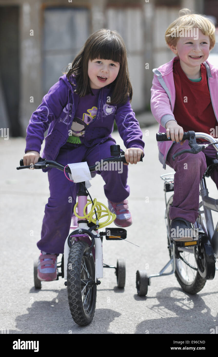 happy childrens group learning to drive bicycle Stock Photo - Alamy