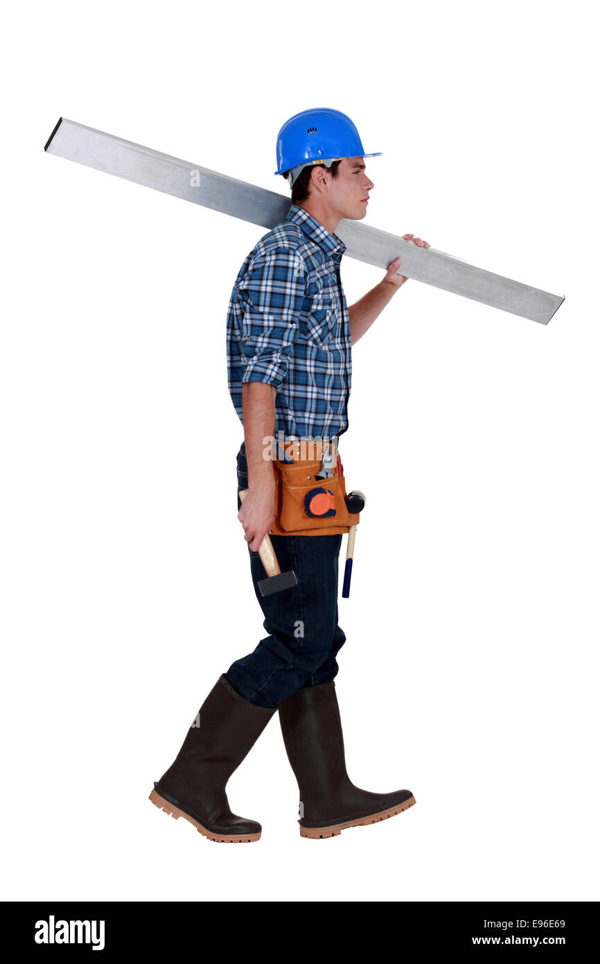 Man carrying metal beam Cut Out Stock Images & Pictures - Alamy