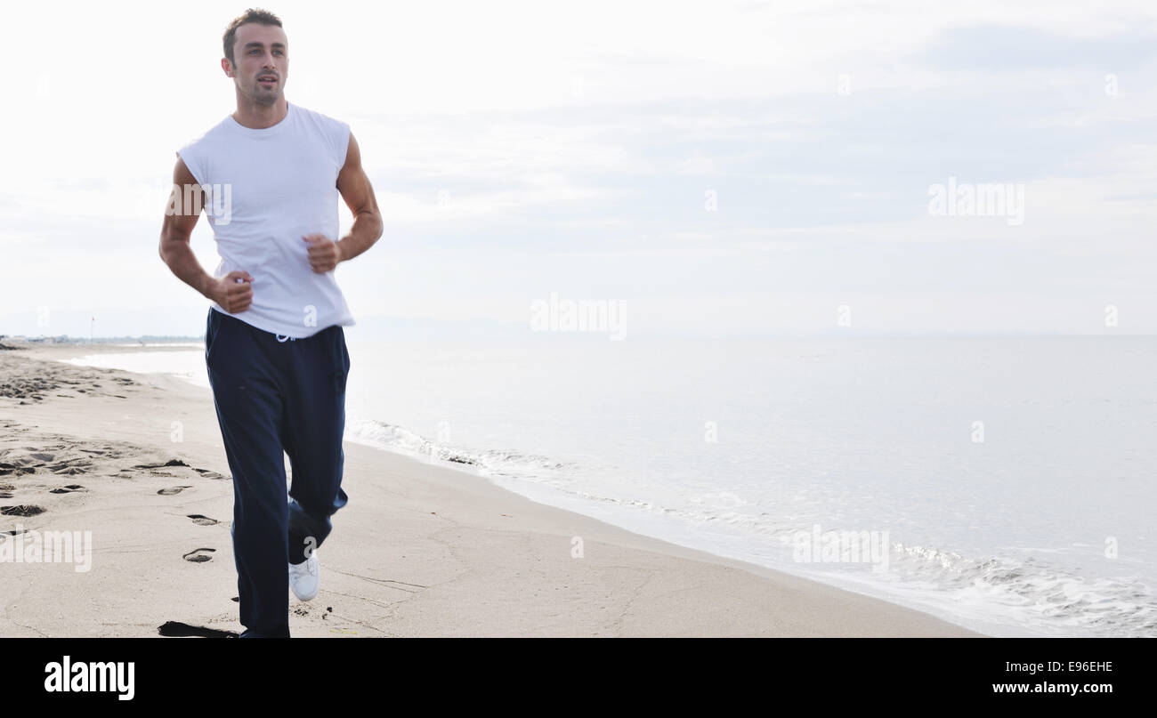 man running on beach Stock Photo - Alamy