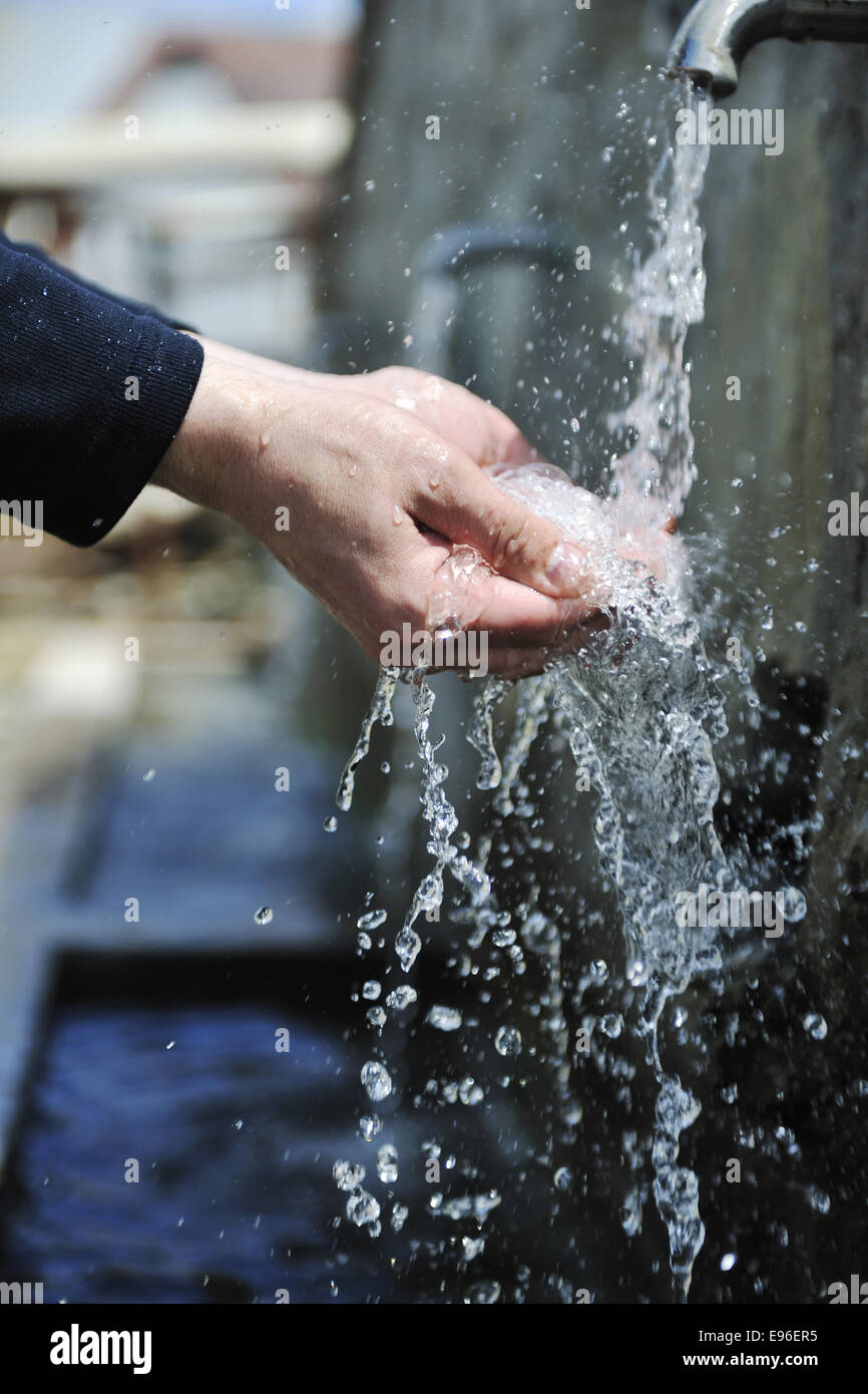 fresh mountain water falling on hands Stock Photo - Alamy