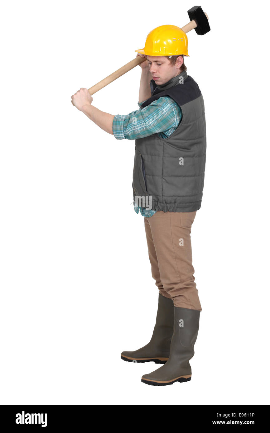 Builder holding hammer over head Stock Photo - Alamy