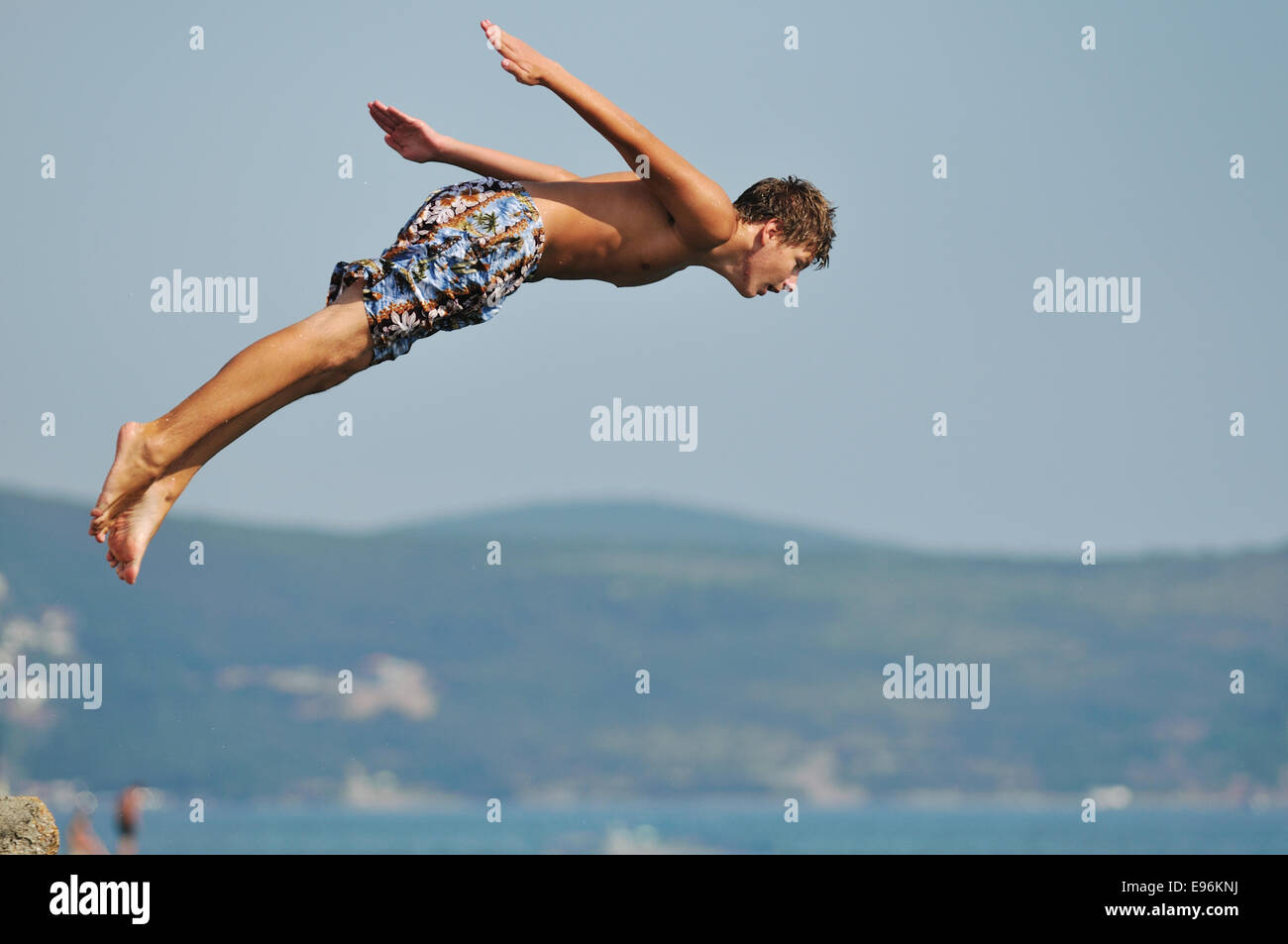 boy jump sea Stock Photo - Alamy