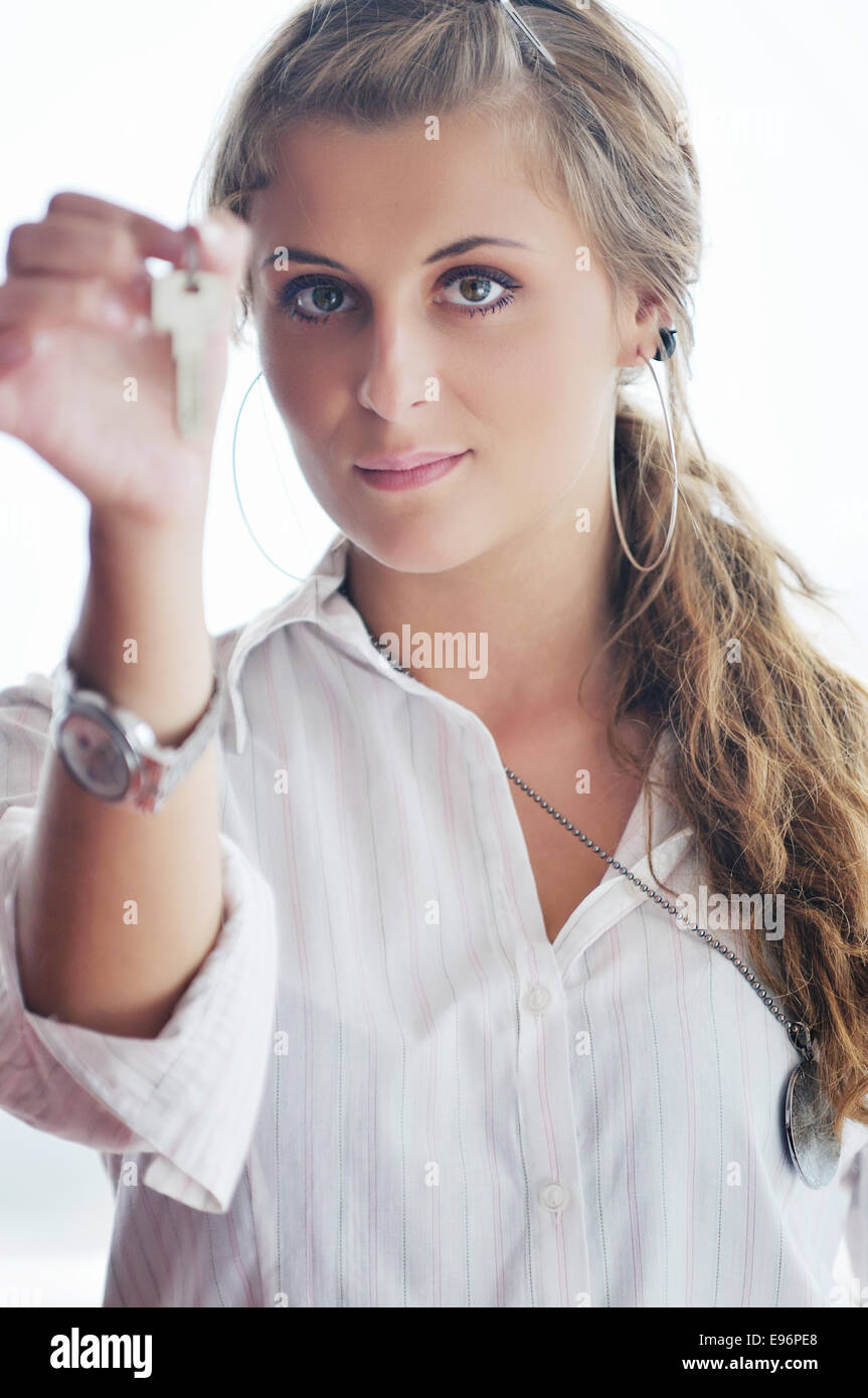 young woman throwing home keys in air Stock Photo - Alamy