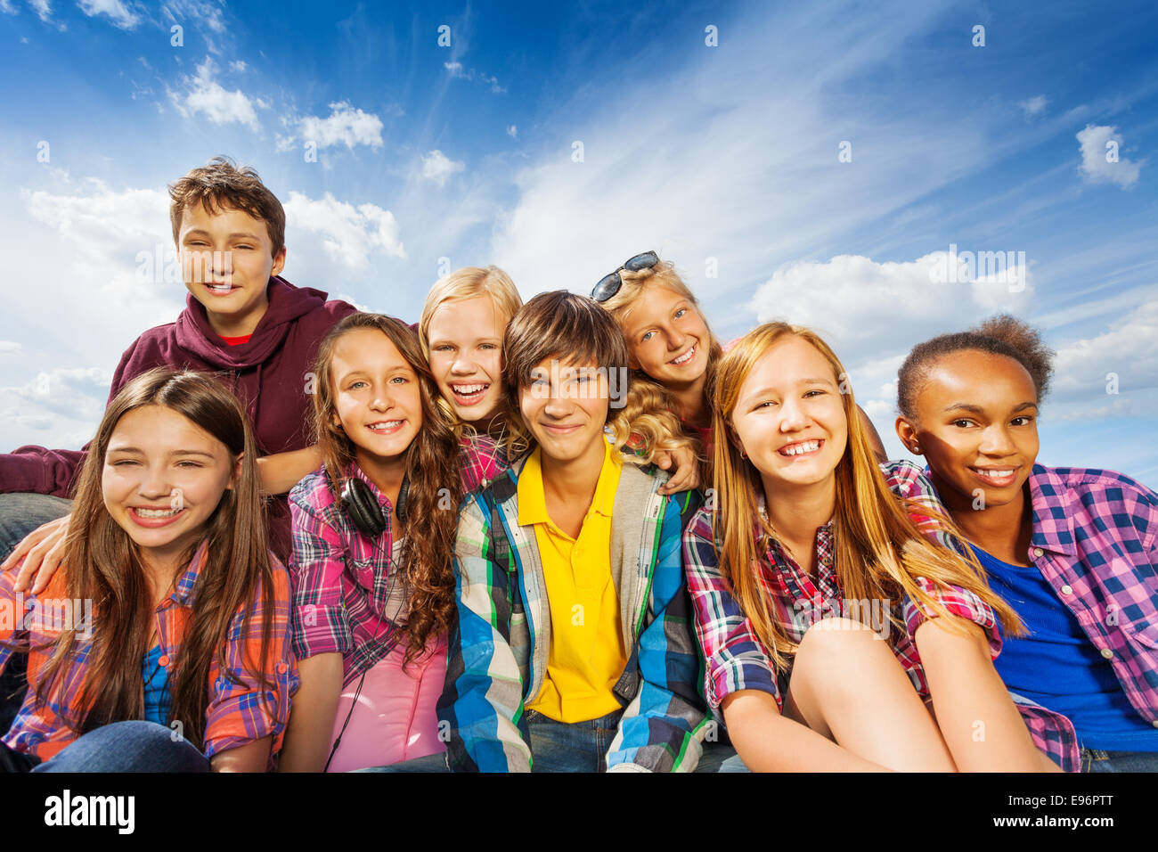 Group of children sitting together and smile Stock Photo - Alamy