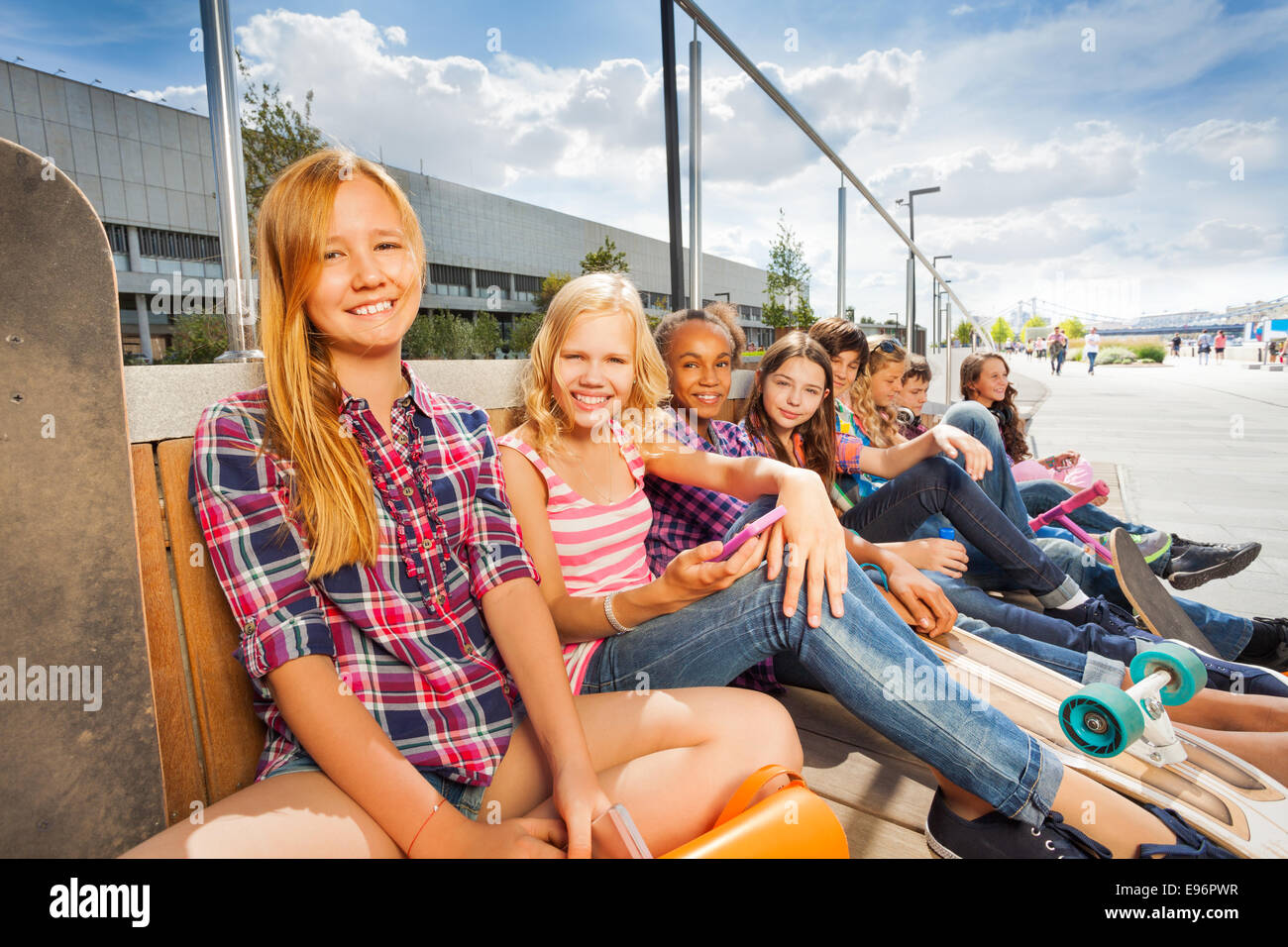 Happy relaxing kids sitting on wooden construction Stock Photo - Alamy