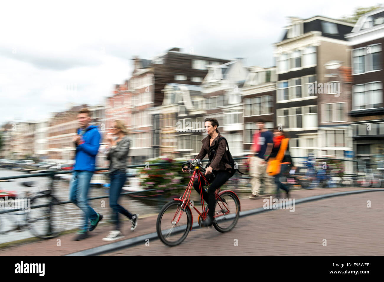 Young woman riding bicycle in Amsterdam Netherlands (Holland) Europe ...