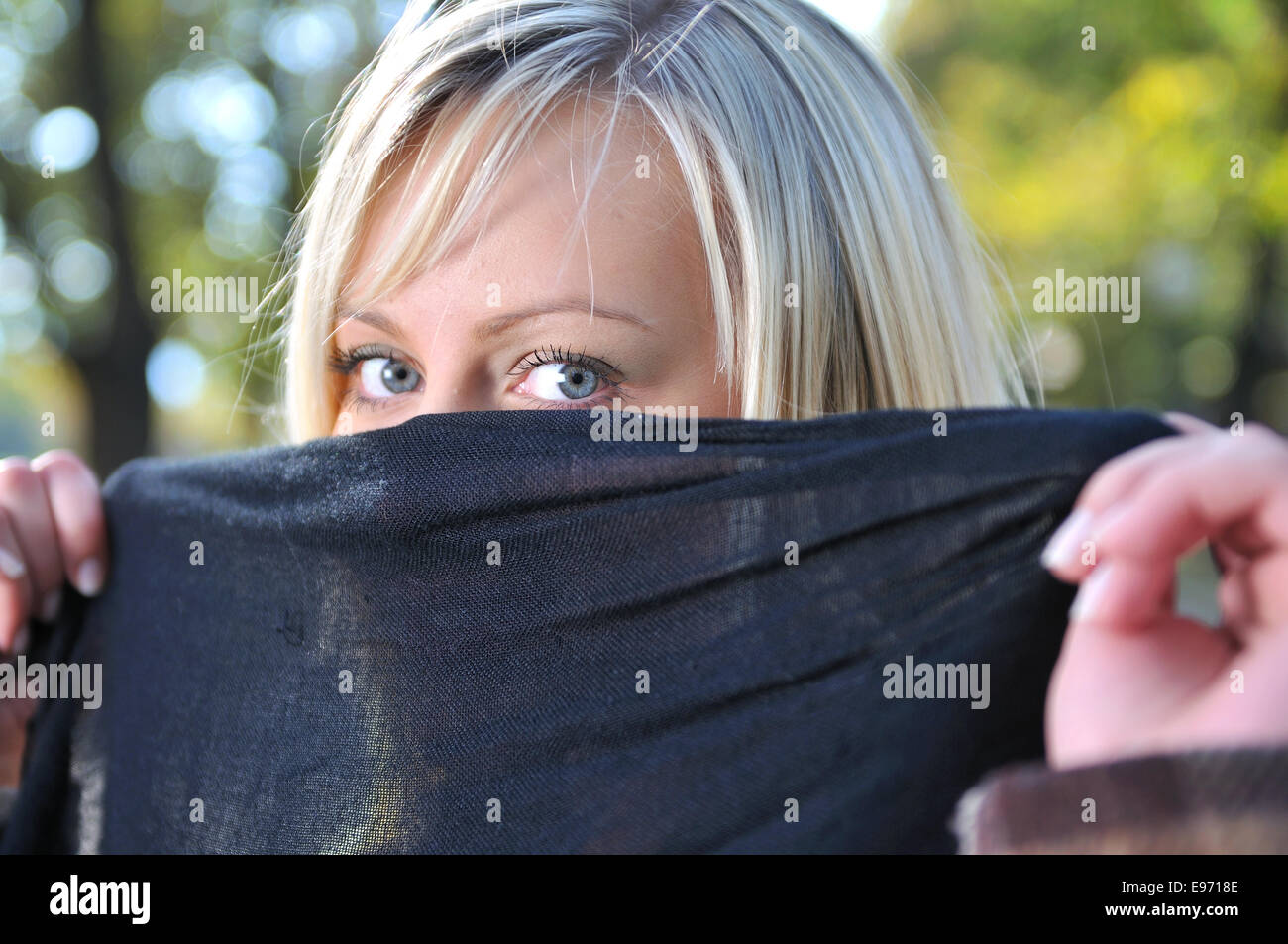 Young woman hiding her face Stock Photo - Alamy