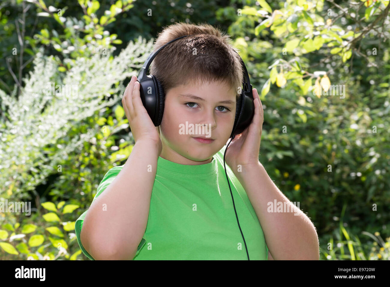 boy listening to music with headphones in park Stock Photo - Alamy