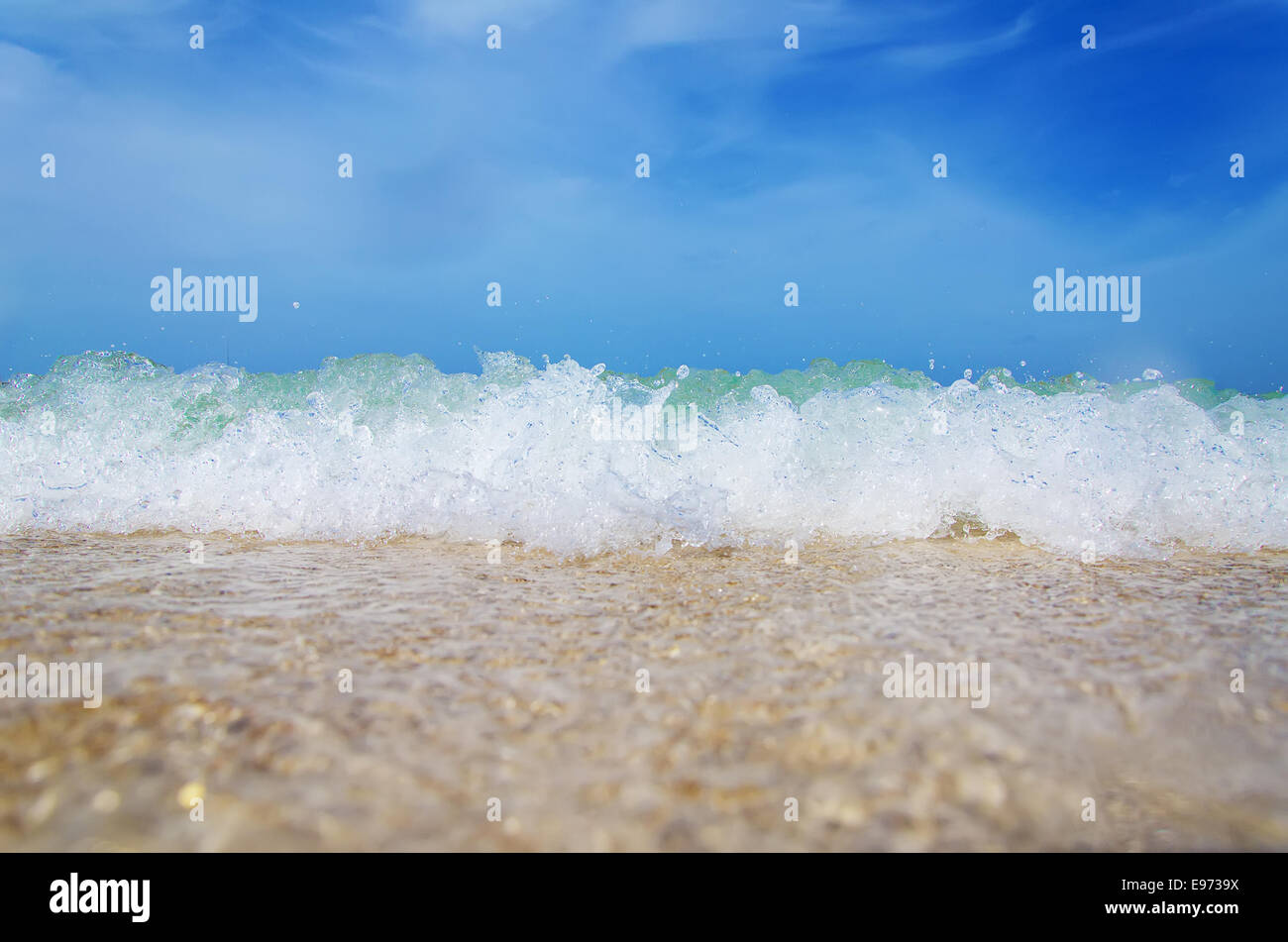 Warm tropic sea waves on the beach Stock Photo - Alamy