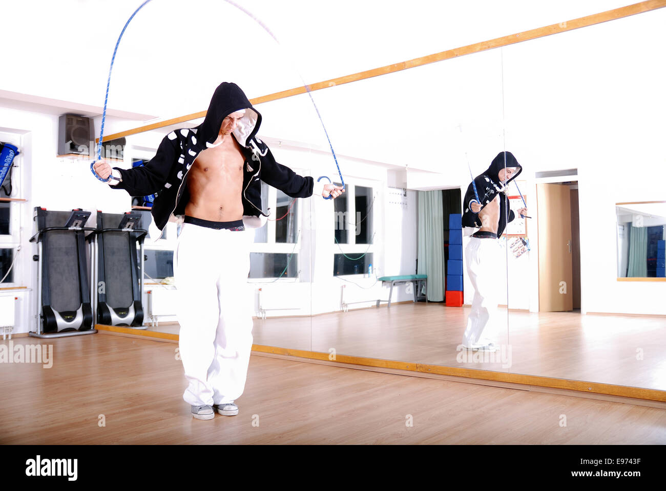 .young man jumping over rope Stock Photo - Alamy