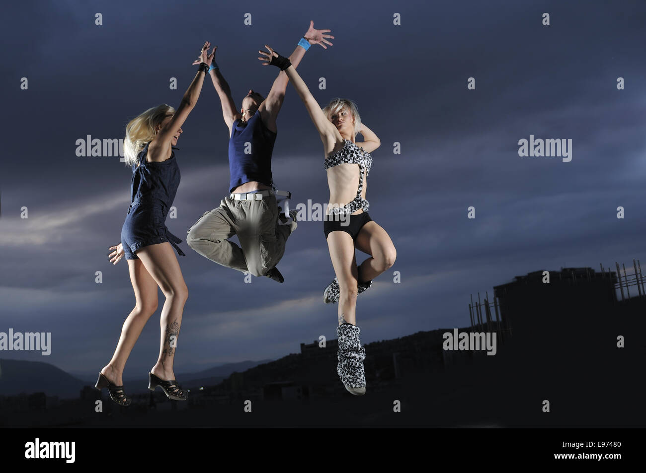 group of people jumping in air in night Stock Photo - Alamy
