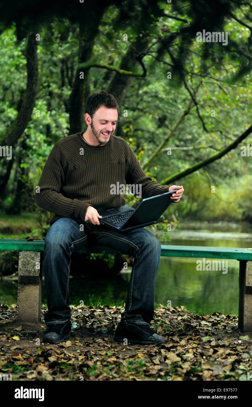 young businessman working on laptop outdoor Stock Photo - Alamy