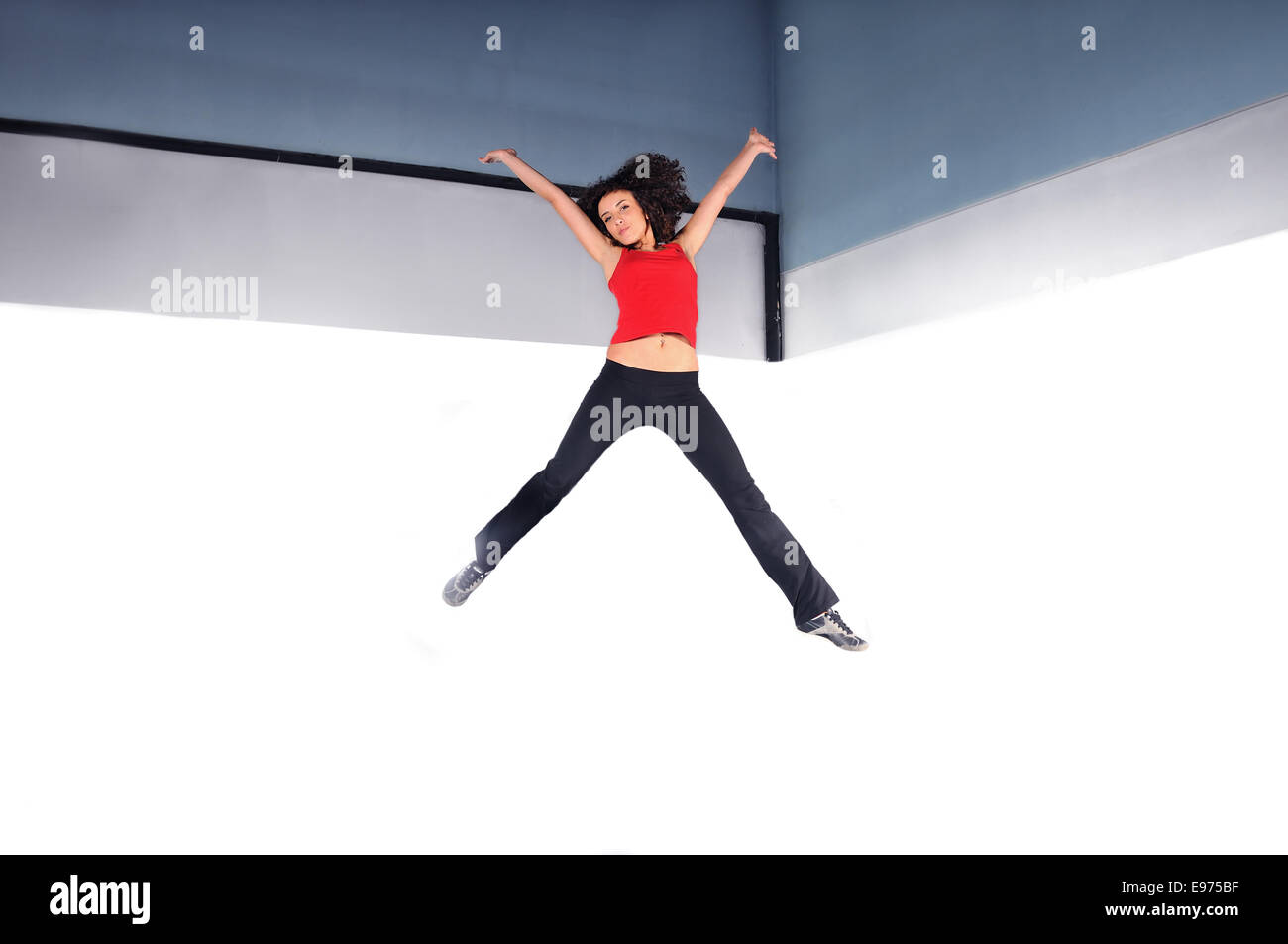 young woman jumping indoor Stock Photo - Alamy
