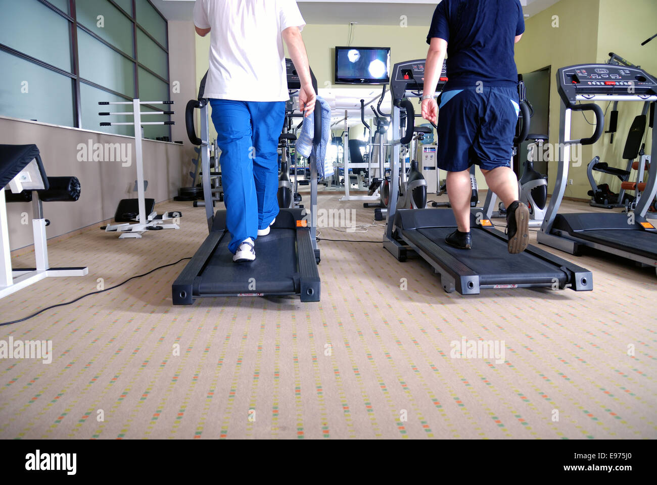 Man running on treadmill in gym Stock Photo - Alamy