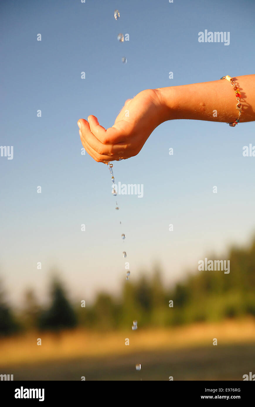 fresh water falling on children hands Stock Photo - Alamy