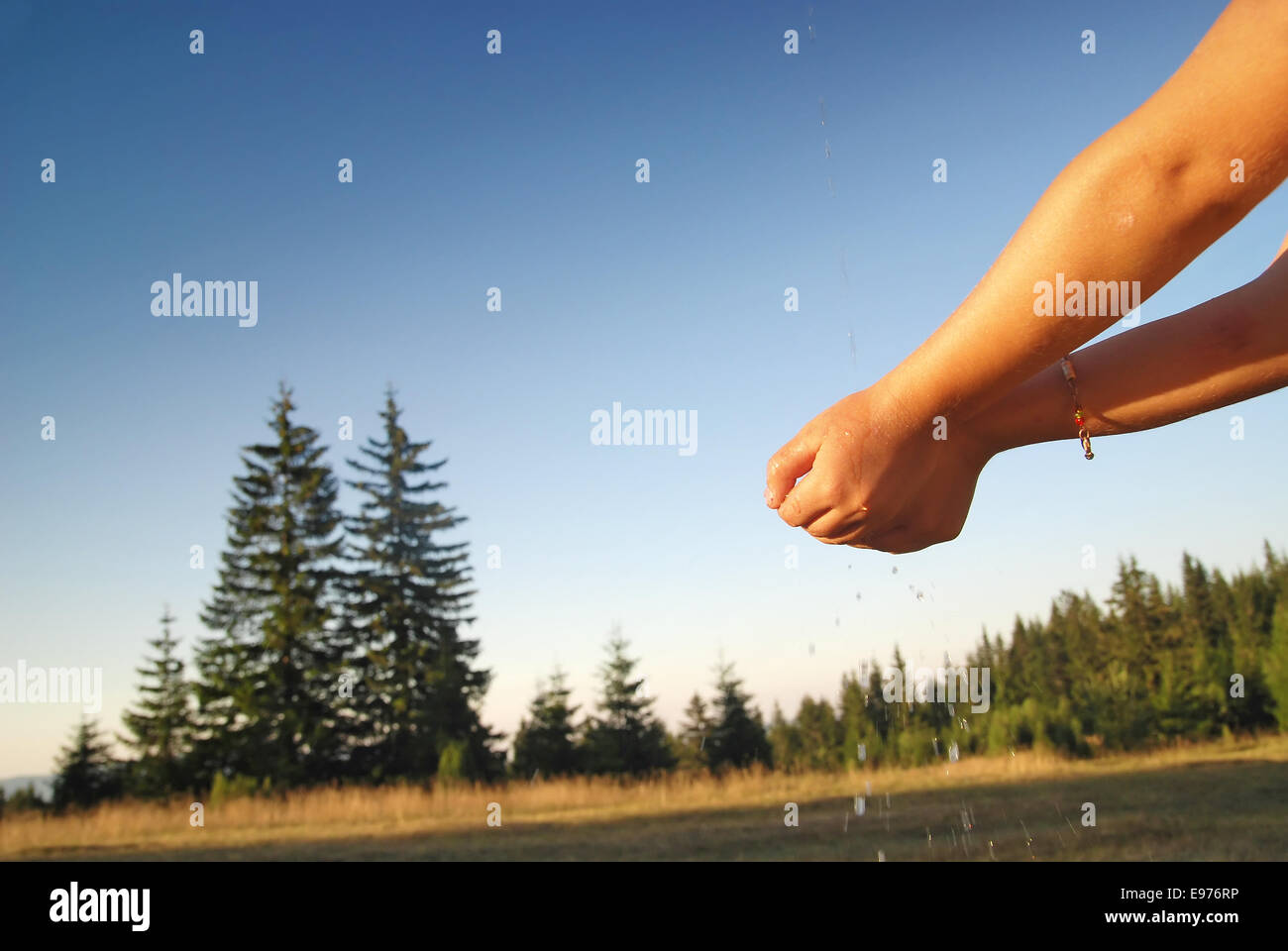 fresh water falling on children hands Stock Photo - Alamy