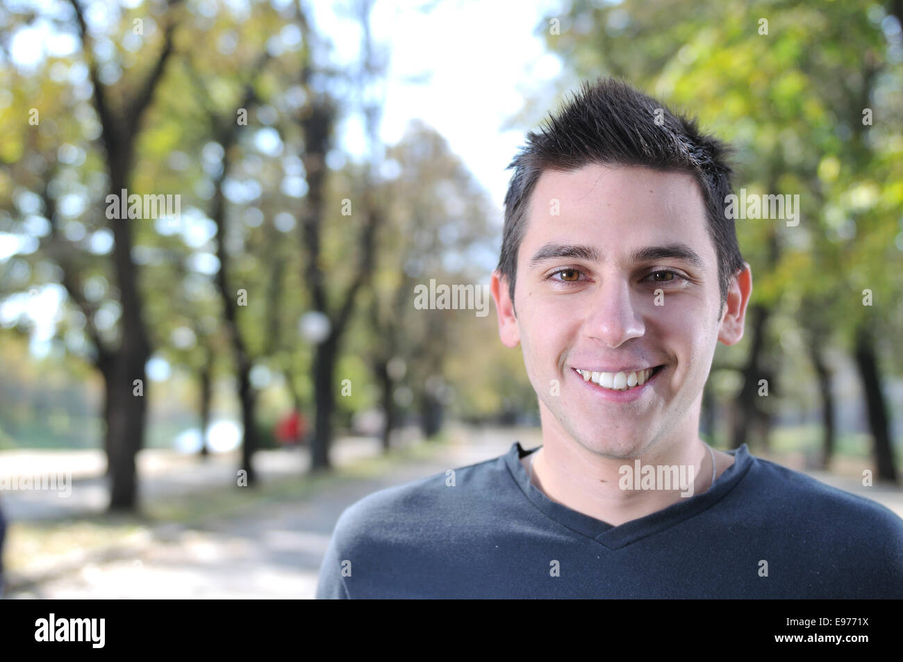 Handsome young man smiling outdoors Stock Photo - Alamy