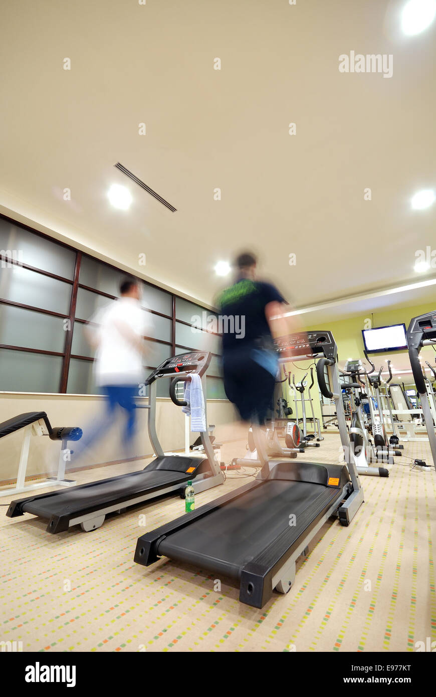 Man running on treadmill in gym Stock Photo - Alamy