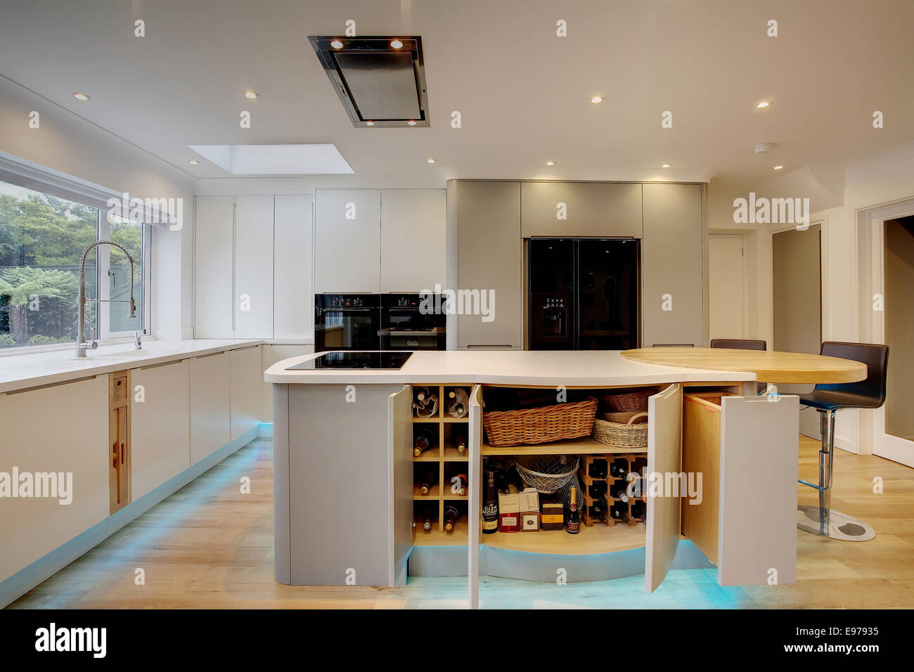 A modern kitchen inside a home in the UK with the doors open on the ...