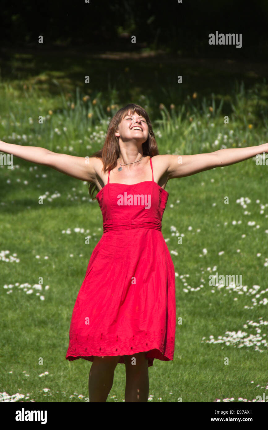 Model dancing on green meadow Stock Photo - Alamy